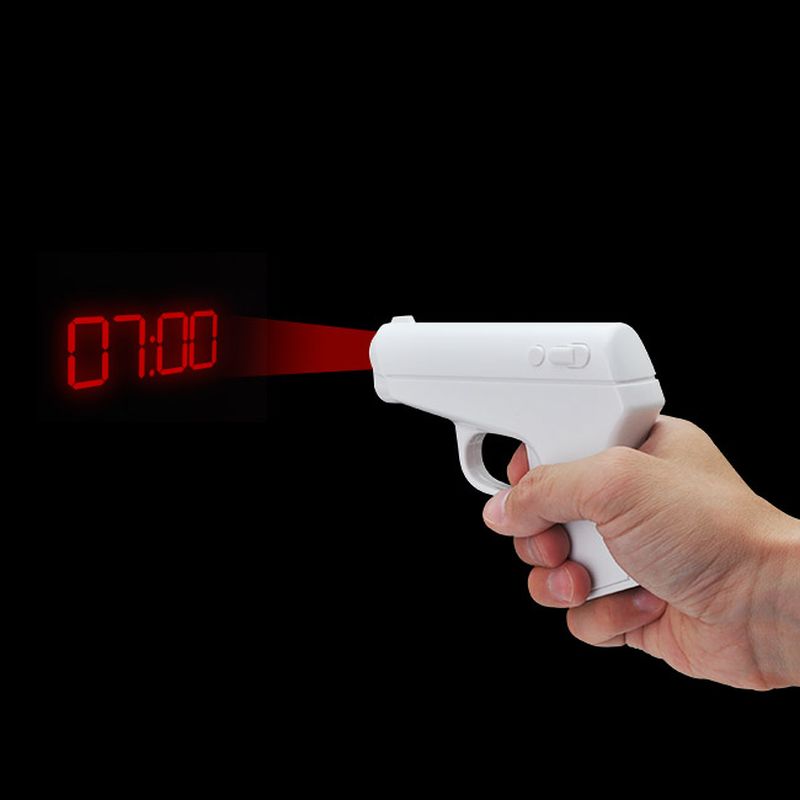 Japanese pistol alarm clock projects digital time on walls - Home Crux