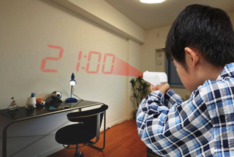 Japanese pistol alarm clock projects digital time on walls - Home Crux